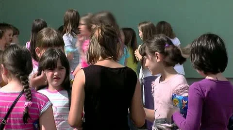 Crowd of little girls have fun and eat s... | Stock Video | Pond5