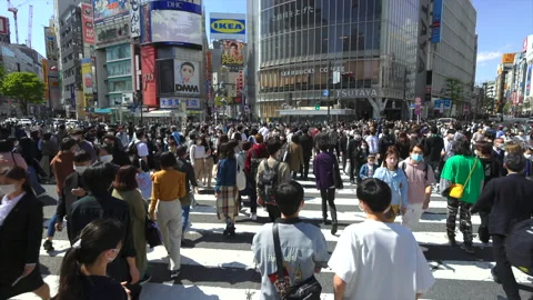 A crowd of people crosses the Shibuya Sc... | Stock Video | Pond5