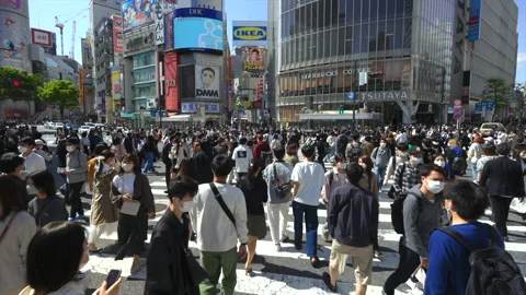 A crowd of people crosses the Shibuya Sc... | Stock Video | Pond5