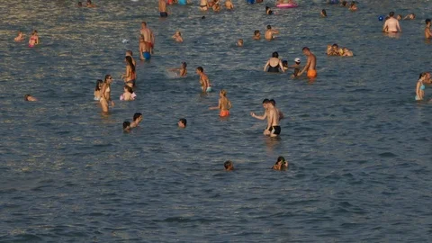 Crowd of people in a crowded beach swimm... | Stock Video | Pond5