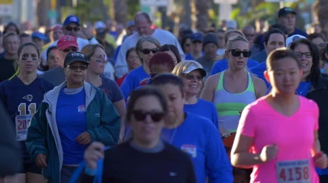 A crowd of people running in a 10K race. | Stock Video | Pond5