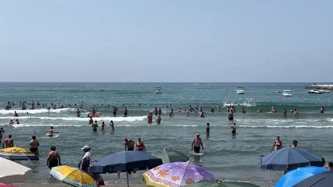 Crowd of people swimming in the sea on c... | Stock Video | Pond5