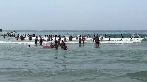 Crowd of people swimming in the sea on c... | Stock Video | Pond5