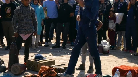 Crowd of people watching young boy snake... | Stock Video | Pond5