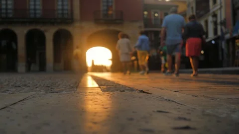 A crowd in a public space at sunset, nea... | Stock Video | Pond5