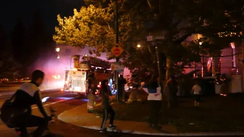 Crowd standing near chaotic scene of a b... | Stock Video | Pond5