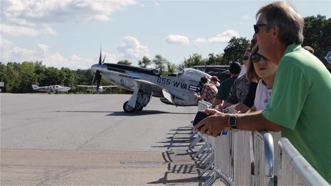 A crowd stands in a row against a metal ... | Stock Video | Pond5