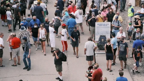 Crowd walks past sign of facts about Big... | Stock Video | Pond5