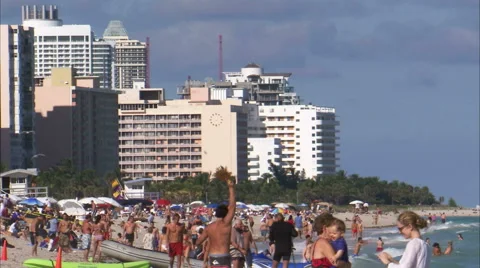 Crowded beach in Miami with hotels in th... | Stock Video | Pond5