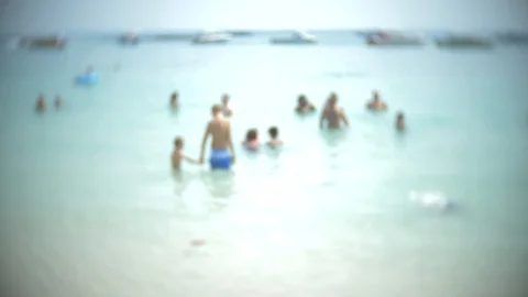Crowded sand beach scene with unrecogniz... | Stock Video | Pond5