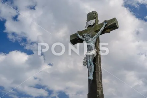 Crucified Jesus. Figure of Jesus Christ against the background of blue sky. O ~ Hi Res #219554333