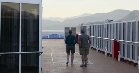 Cruise ship couple playing deck shuffle ... | Stock Video | Pond5