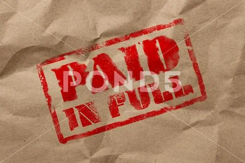 Photograph: Crumpled kraft paper with stamp PAID IN FULL, top view ...