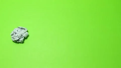 crumpled paper ball on green background. | Stock Video | Pond5
