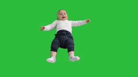 Crying baby boy laying on a Green Screen... | Stock Video | Pond5