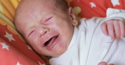 Crying baby boy at rocking cradle | Stock Video | Pond5