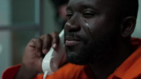 Crying Black Inmate Talking on Phone in ... | Stock Video | Pond5
