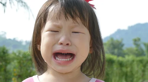 Crying child on natural background | Stock Video | Pond5