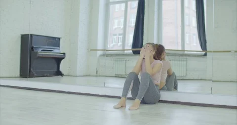 Crying female dancer leaning on mirror i... | Stock Video | Pond5