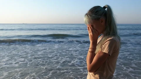 Crying girl by turquoise sea. | Stock Video | Pond5