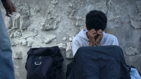 Crying homeless man sitting street, pass... | Stock Video | Pond5