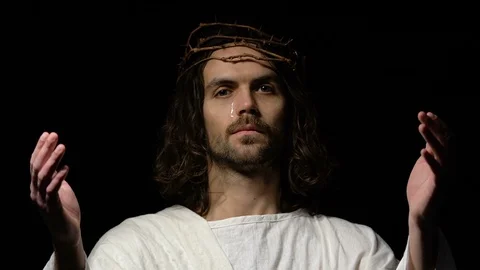 Crying Jesus in crown of thorns raising ... | Stock Video | Pond5