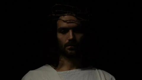 Crying Jesus in crown of thorns raising ... | Stock Video | Pond5