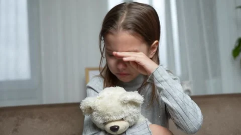 Crying little girl with teddy bear toy s... | Stock Video | Pond5