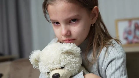Crying little girl with teddy bear toy s... | Stock Video | Pond5