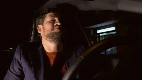 Crying man driving car at night in city ... | Stock Video | Pond5