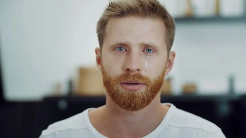 Crying tears in eyes of depressed ginger... | Stock Video | Pond5