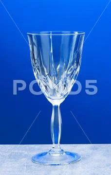 Photograph: Crystal glass with close-up on a blue background #123795907