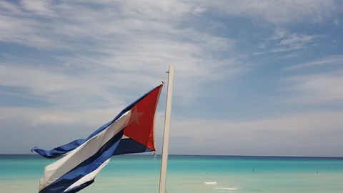 Cuban flag on the beach, flying in the w... | Stock Video | Pond5