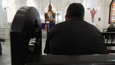 Cuban man praying in cathedral | Stock Video | Pond5