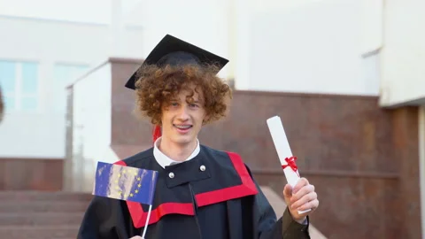 A curly funny graduate in the master's m... | Stock Video | Pond5