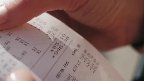 Customer checks paper receipt on superma... | Stock Video | Pond5