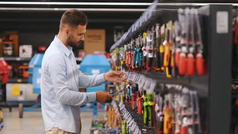 A customer in a hardware store chooses t... | Stock Video | Pond5