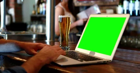 Customer using a laptop with green scree... | Stock Video | Pond5