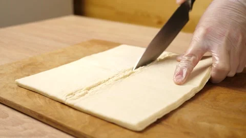 Cut the puff pastry in half with a knife... | Stock Video | Pond5