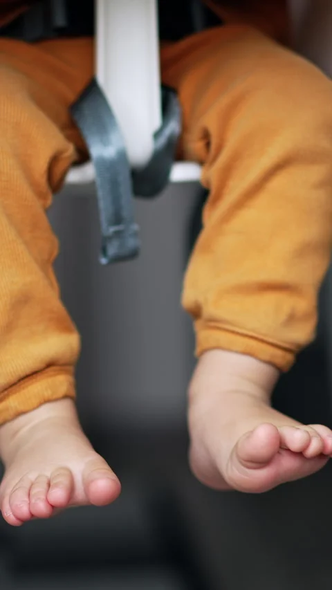 Cute adorable bare feet of a kid sitting... | Stock Video | Pond5