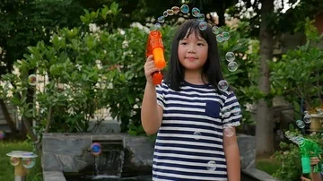 Cute Asian children Shooting Bubbles fro... | Stock Video | Pond5