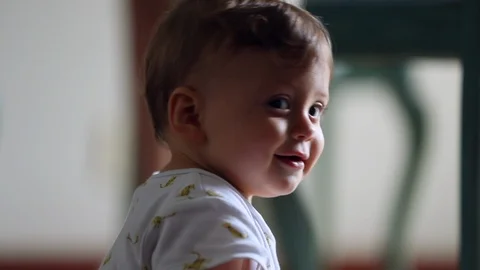 Cute baby boy turning head towards camer... | Stock Video | Pond5