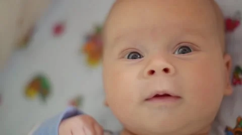 A cute baby feels confused. Close up of ... | Stock Video | Pond5