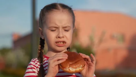 Cute baby girl eating fast food burger w... | Stock Video | Pond5