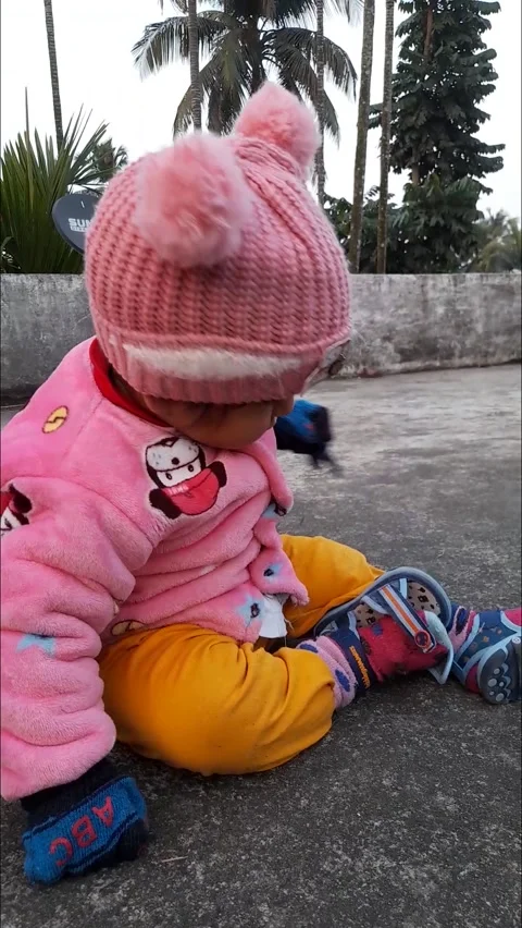 Cute baby in pink Cute Baby sitting Outd... | Stock Video | Pond5