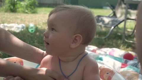 cute baby playing pool summer, backyard,... | Stock Video | Pond5