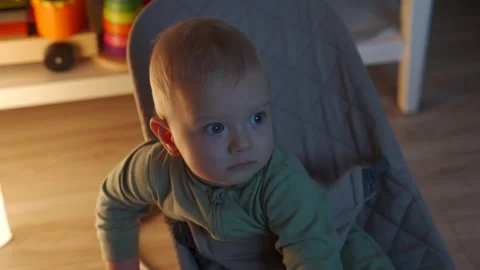 Cute baby is watching tv, face of child ... | Stock Video | Pond5