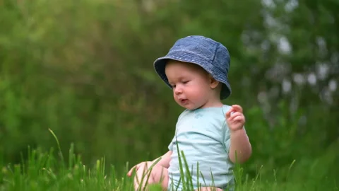 Cute baby7-8 months old in the park sitt... | Stock Video | Pond5