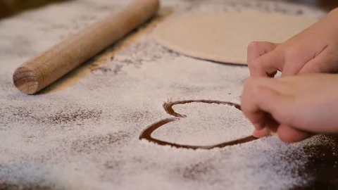 Cute boy drawing into flour heart shape ... | Stock Video | Pond5
