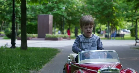 Cute Boy Drives Electric Red Car. Kid Ch... | Stock Video | Pond5